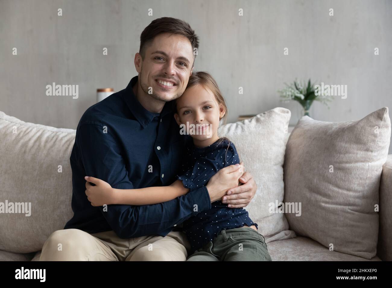Head shot portrait smiling loving father hugging 8s daughter Stock ...