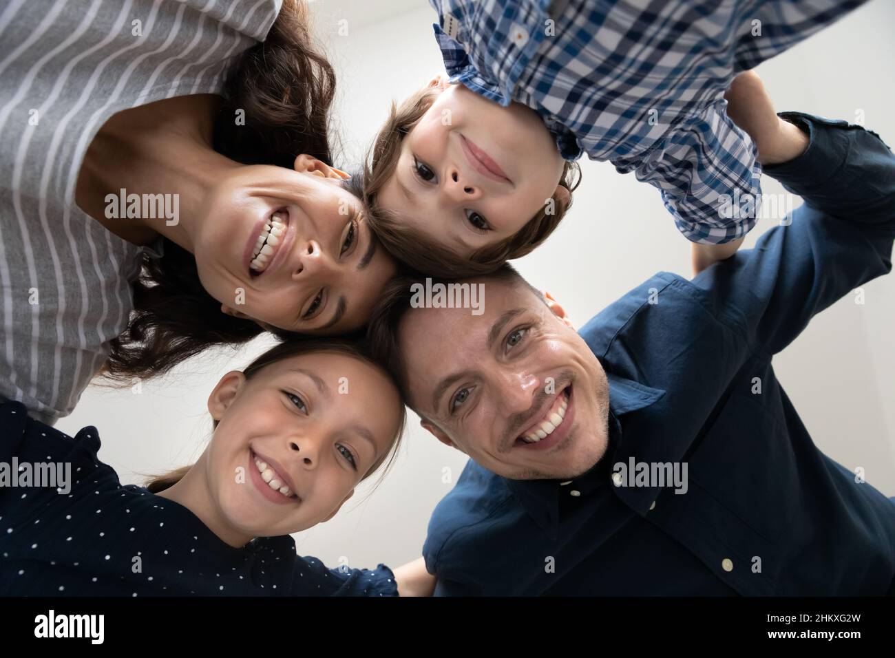 Close up low angle portrait happy family with kids Stock Photo - Alamy