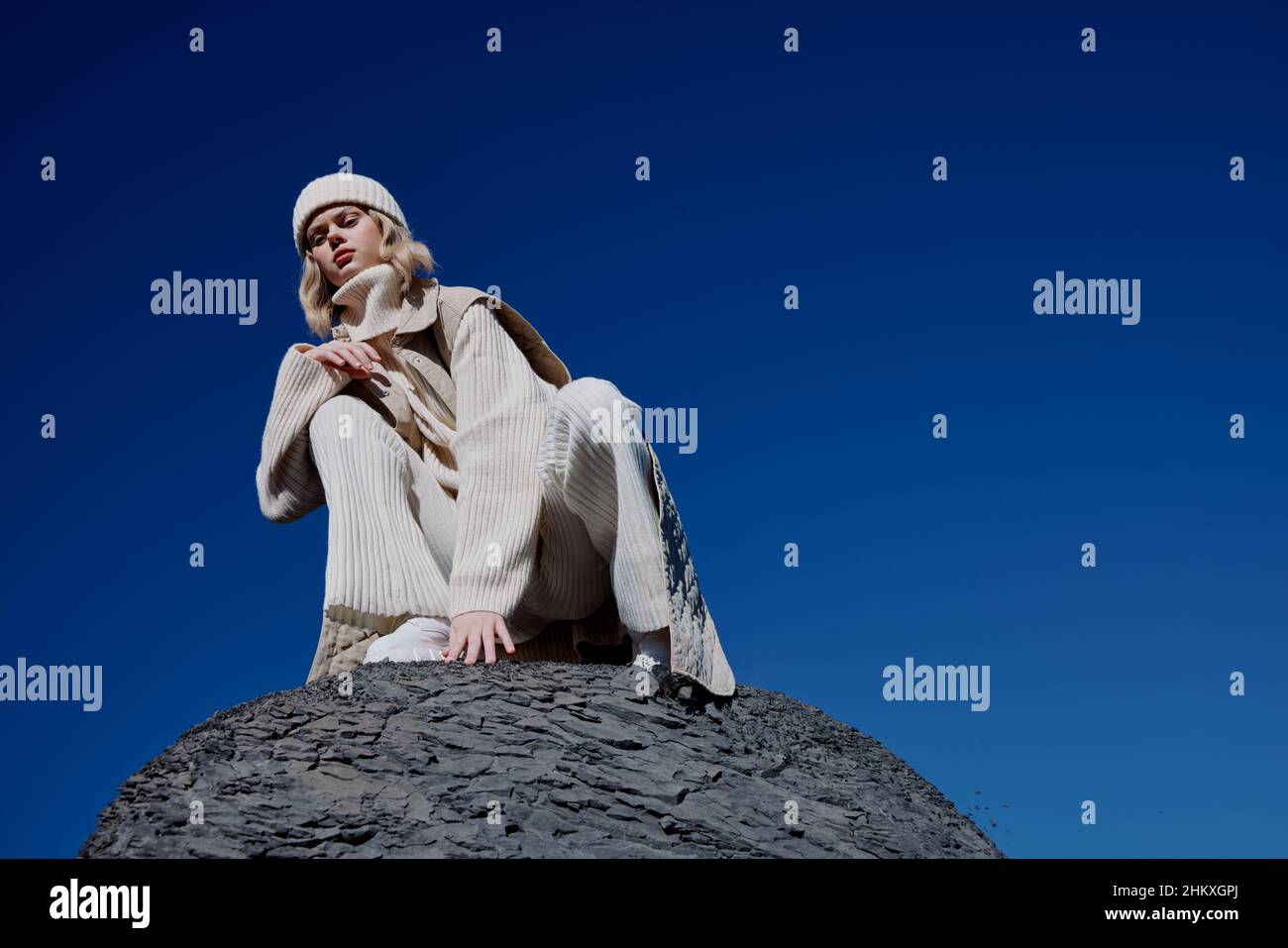 Woman sitting stone mountainscape hi-res stock photography and images ...