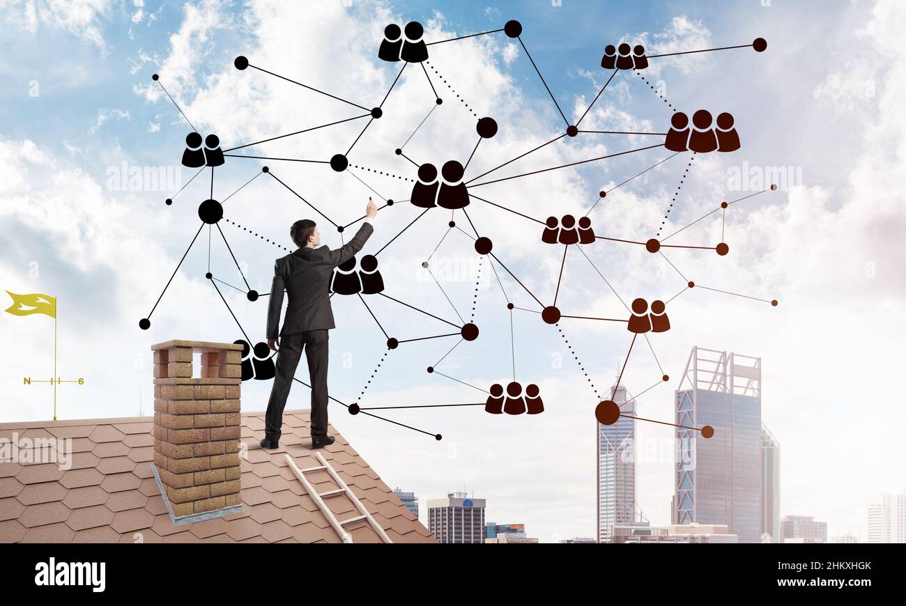 Businessman on house roof presenting networking and connection concept ...