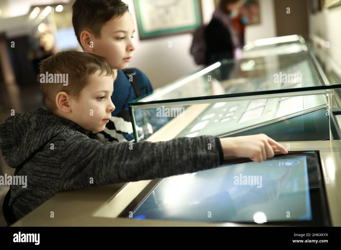 Portrait of kids using touch screen in Entertainment Center Stock Photo ...