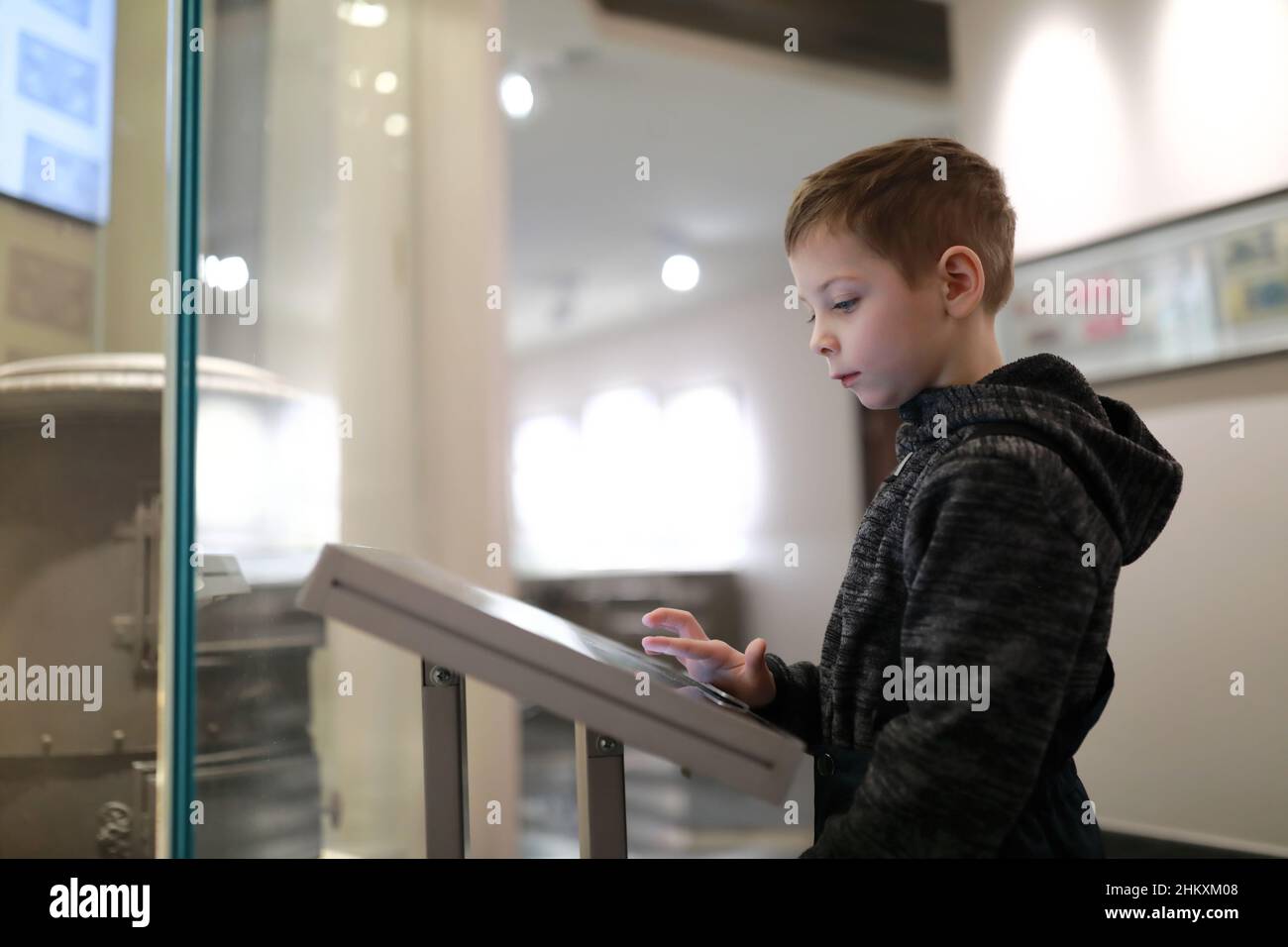 Portrait of boy using touch screen in Entertainment Center Stock Photo ...