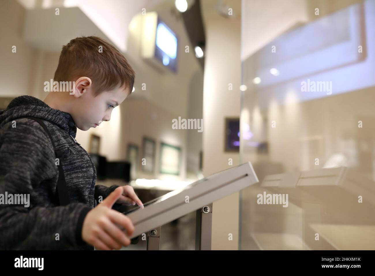 Portrait of child using touch screen in Entertainment Center Stock ...