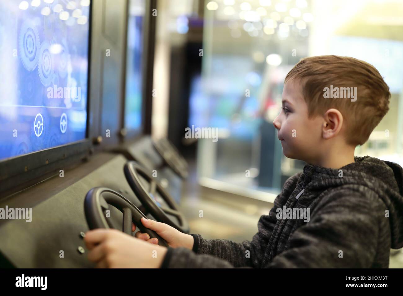 Portrait of child playing racing simulator game Stock Photo - Alamy