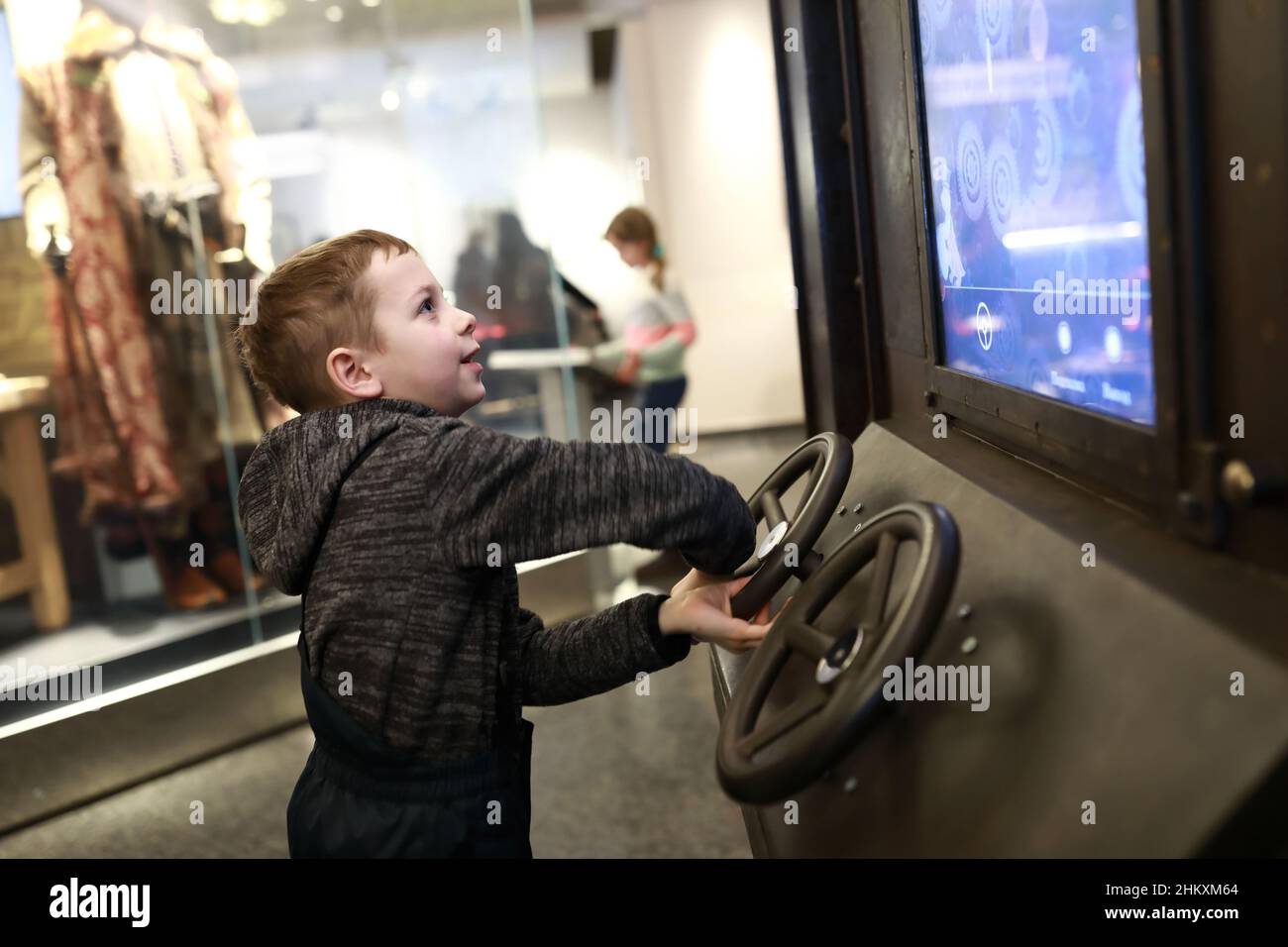 Portrait of kid playing racing simulator game Stock Photo - Alamy