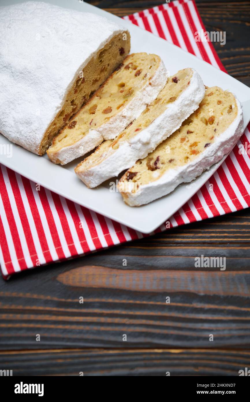 Sliced Traditional Christmas stollen cake with marzipan and dried fruit ...