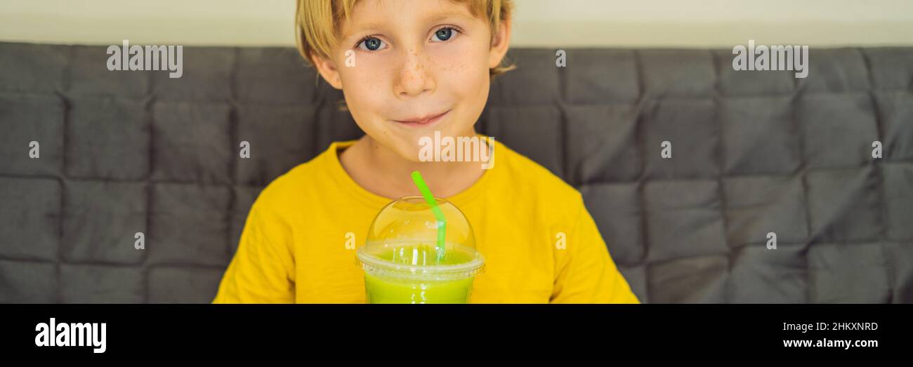 The boy is drinking Green tea latte with ice in mason jar. Homemade ...