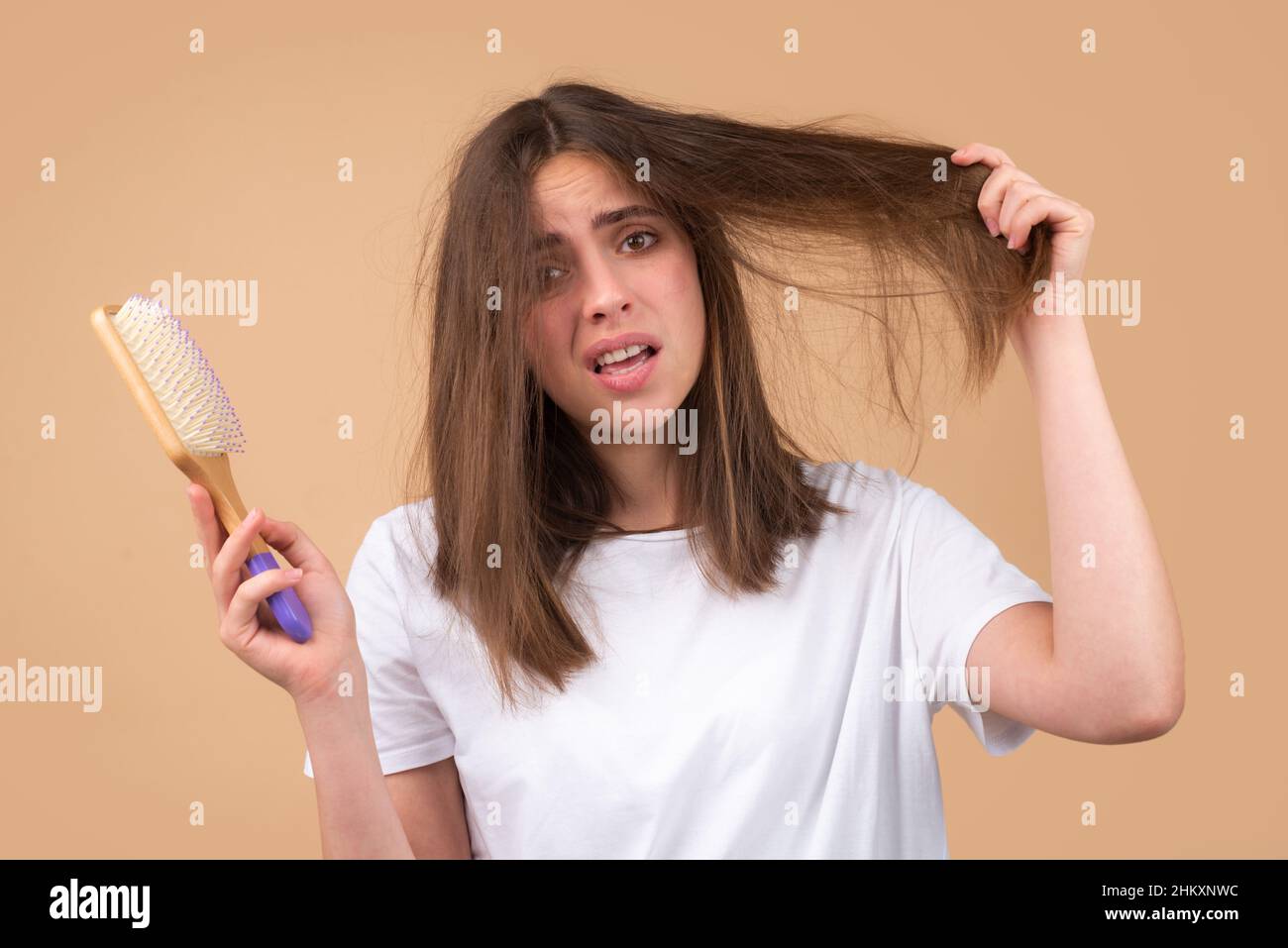 Sad woman with straight brushed hair. Hair tangling problem. Unhappy ...