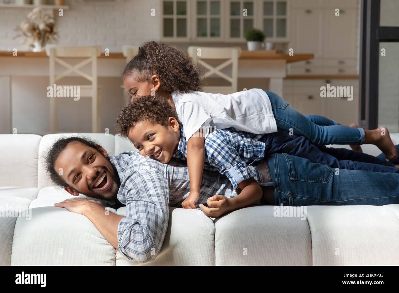 Joyful laughing little kids playing with father Stock Photo - Alamy