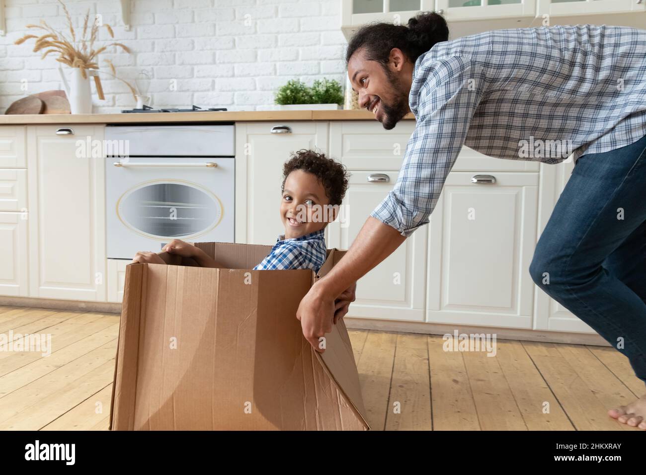 Happy small kid boy playing with African father Stock Photo - Alamy