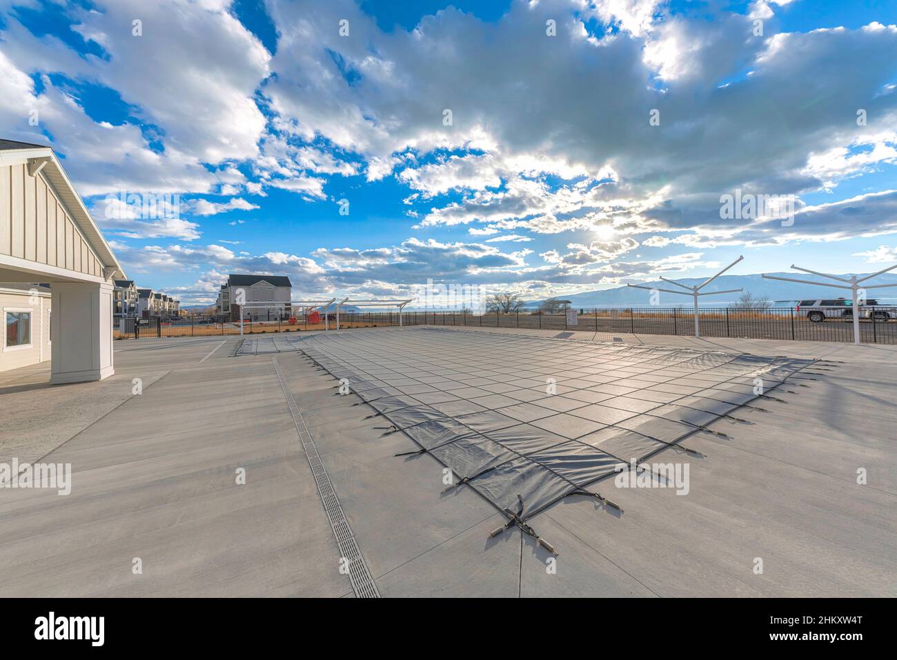 Covered community pool in a residential area with concrete ground and ...