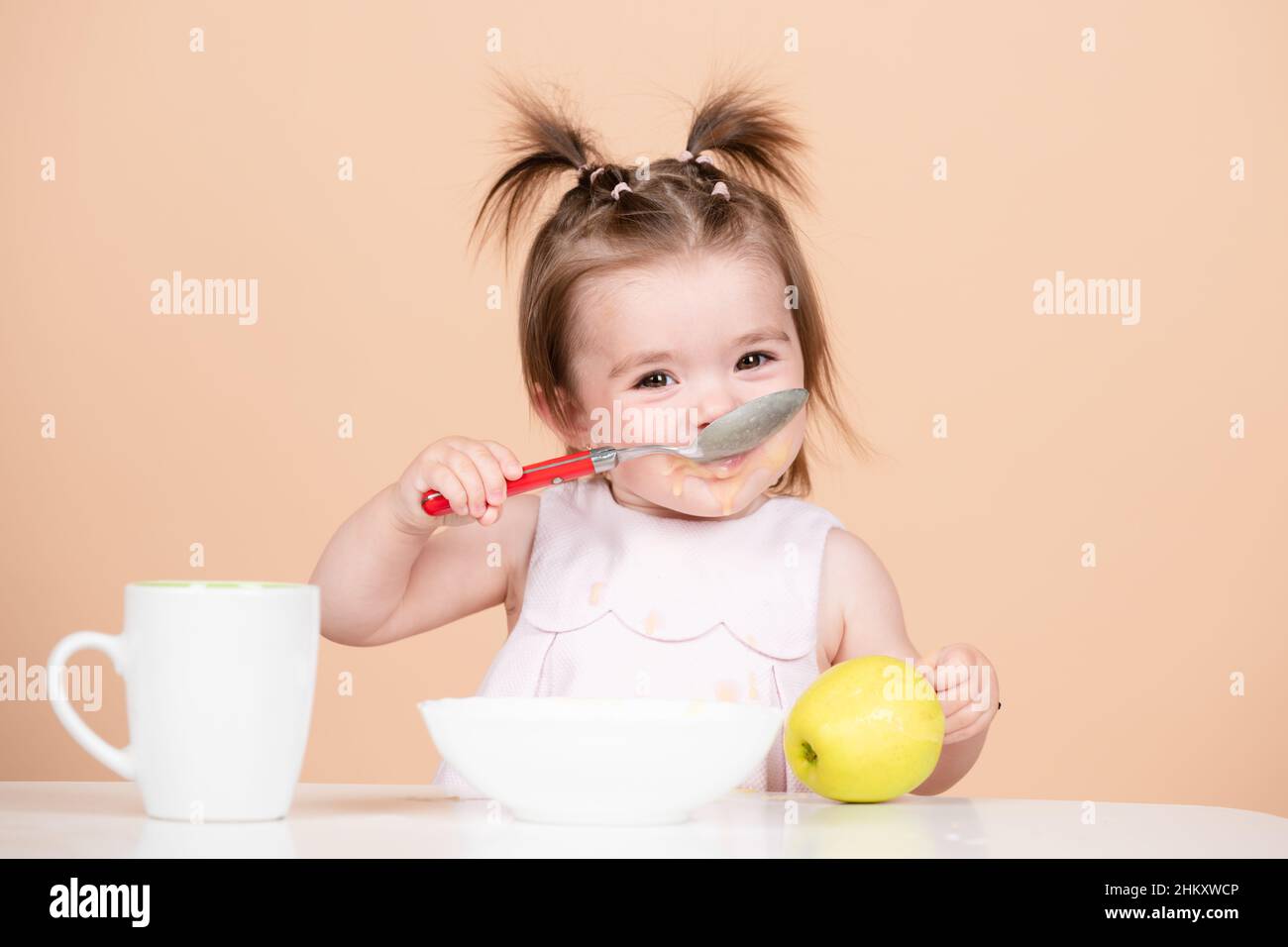 Cute baby child eat food, babies eating. Happy smiling baby with spoon ...