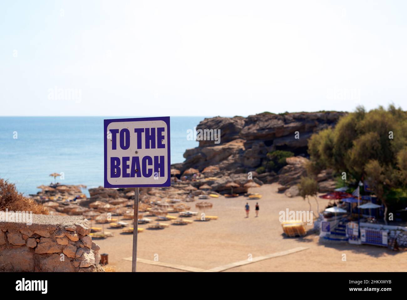 Sign showing way to the beach at the entrance to sandy beach in Greece ...