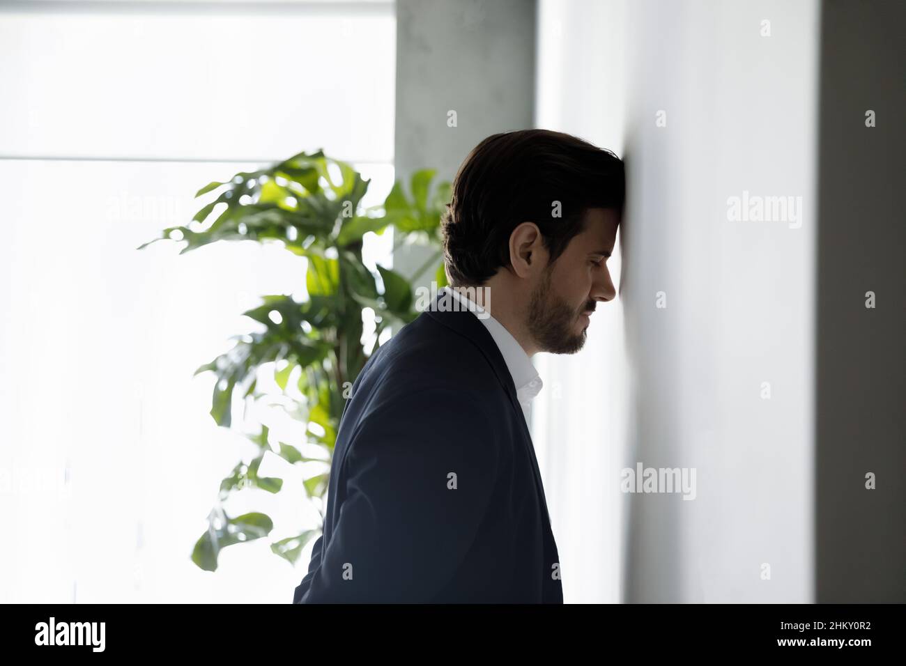 Frustrated man leaning head wall hi-res stock photography and images ...