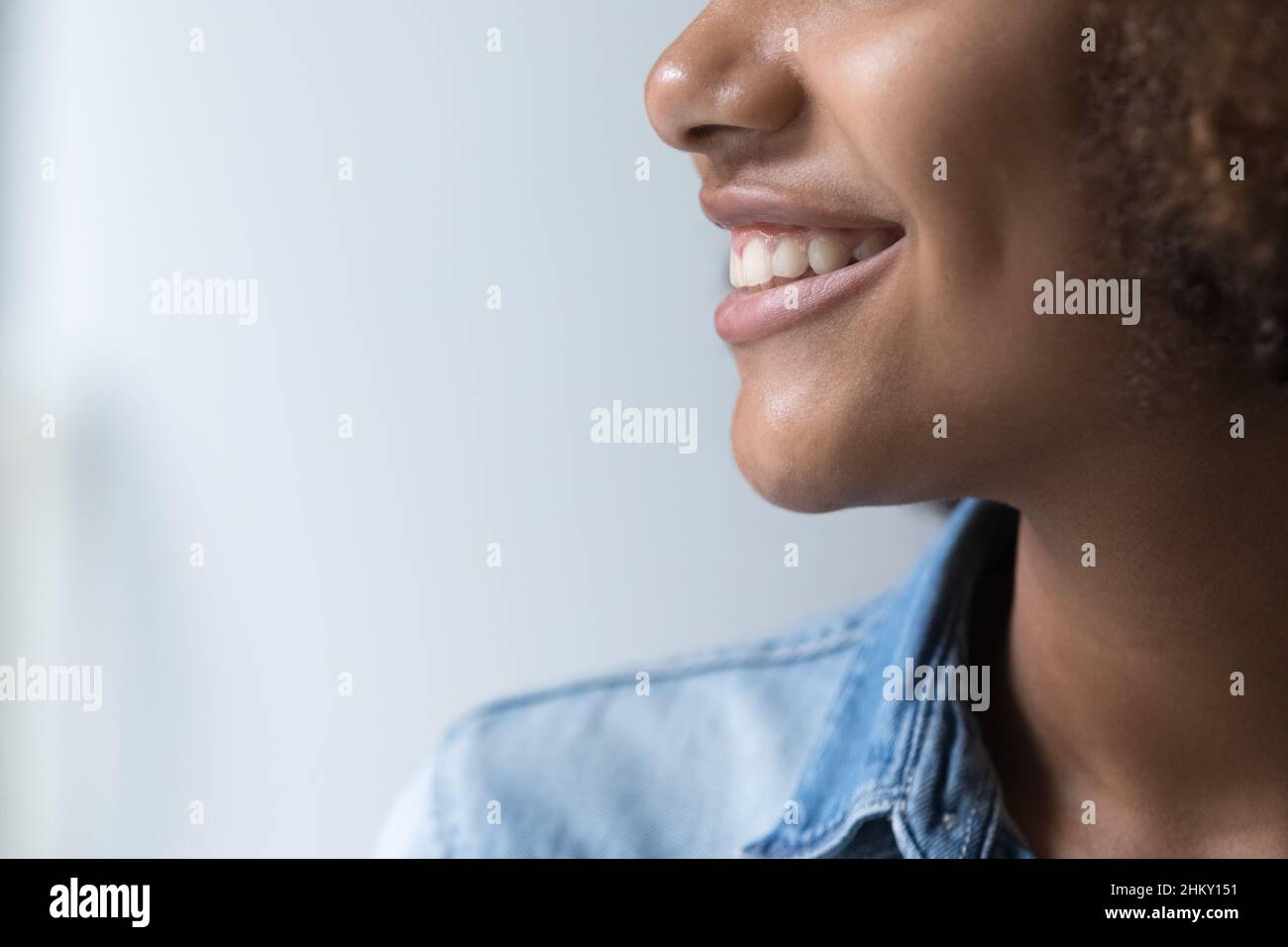 Lower face of happy beautiful Black ten girl side view Stock Photo - Alamy