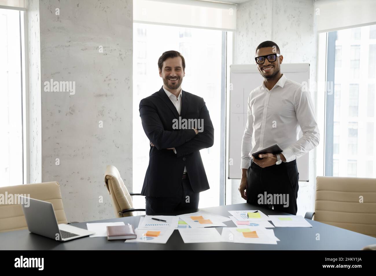 Happy diverse business project partners enjoying teamwork over paper ...