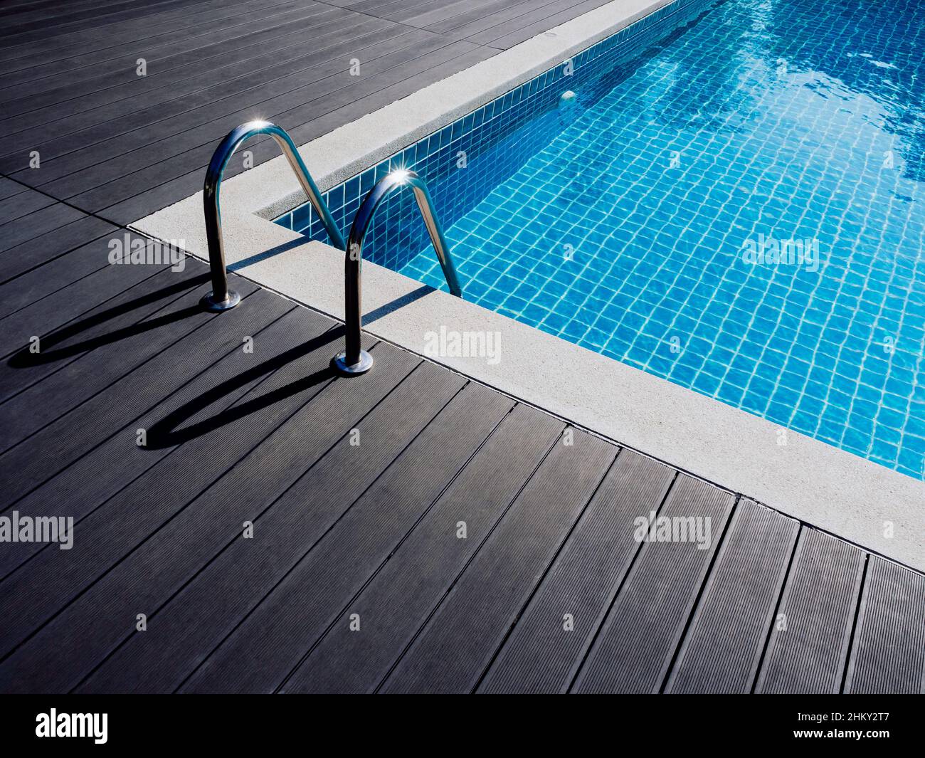 Stone edge frame on the square swimming pool with clean clear water ...