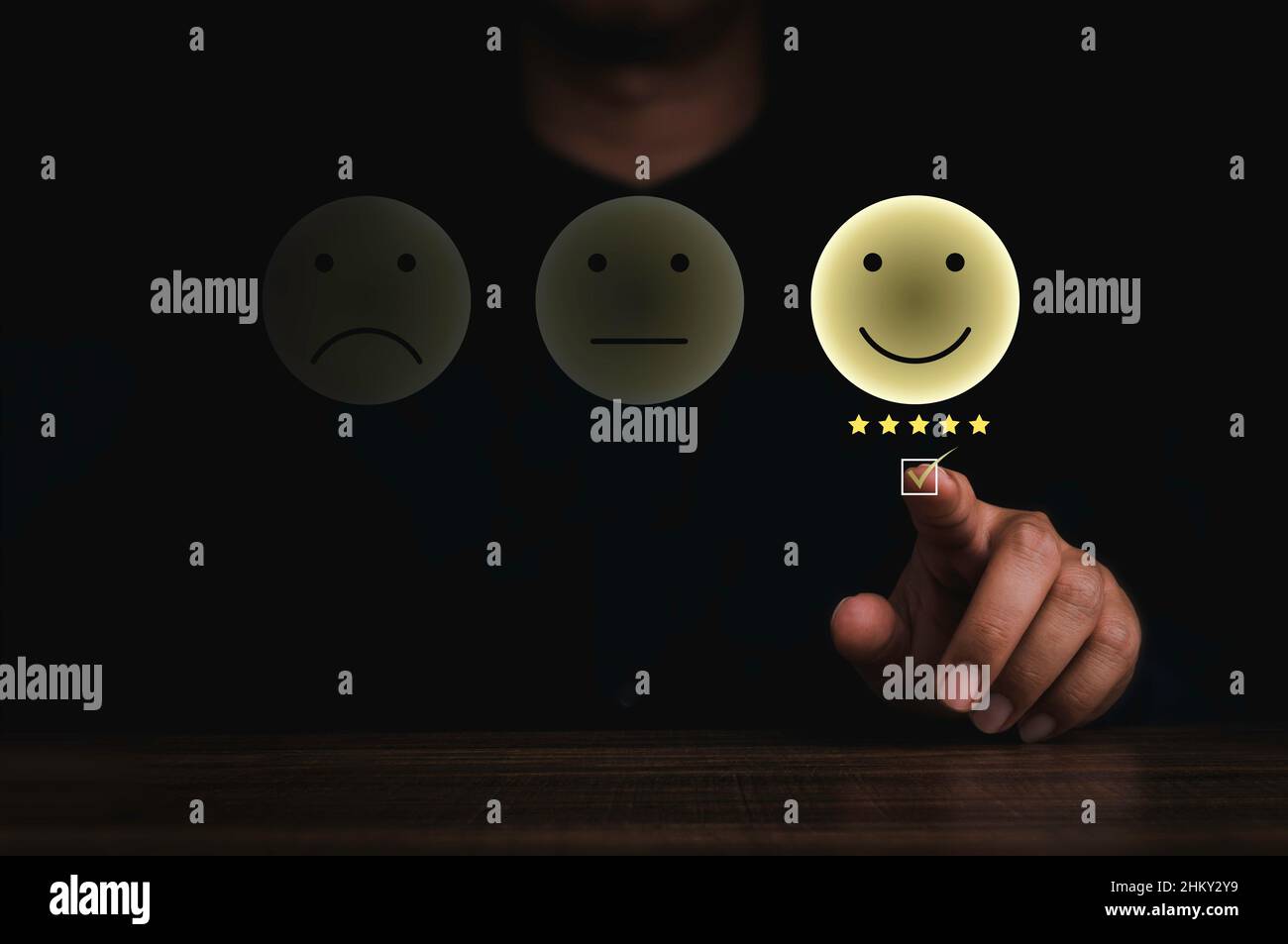 Businessman's hand pressing with a checkmark on checkbox on smiley face ...