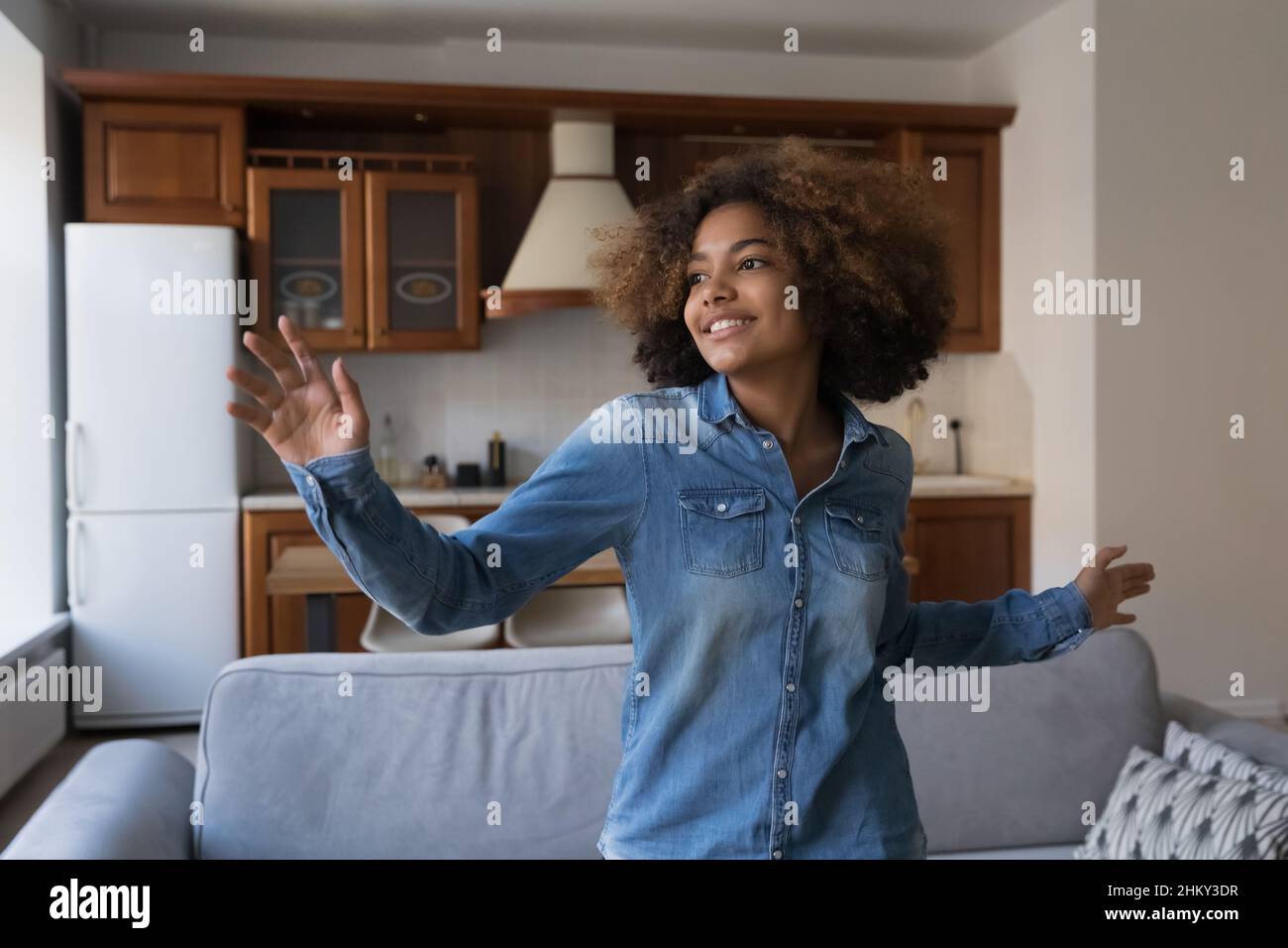Happy Active teen Black girl woman dancing in home interior Stock Photo ...