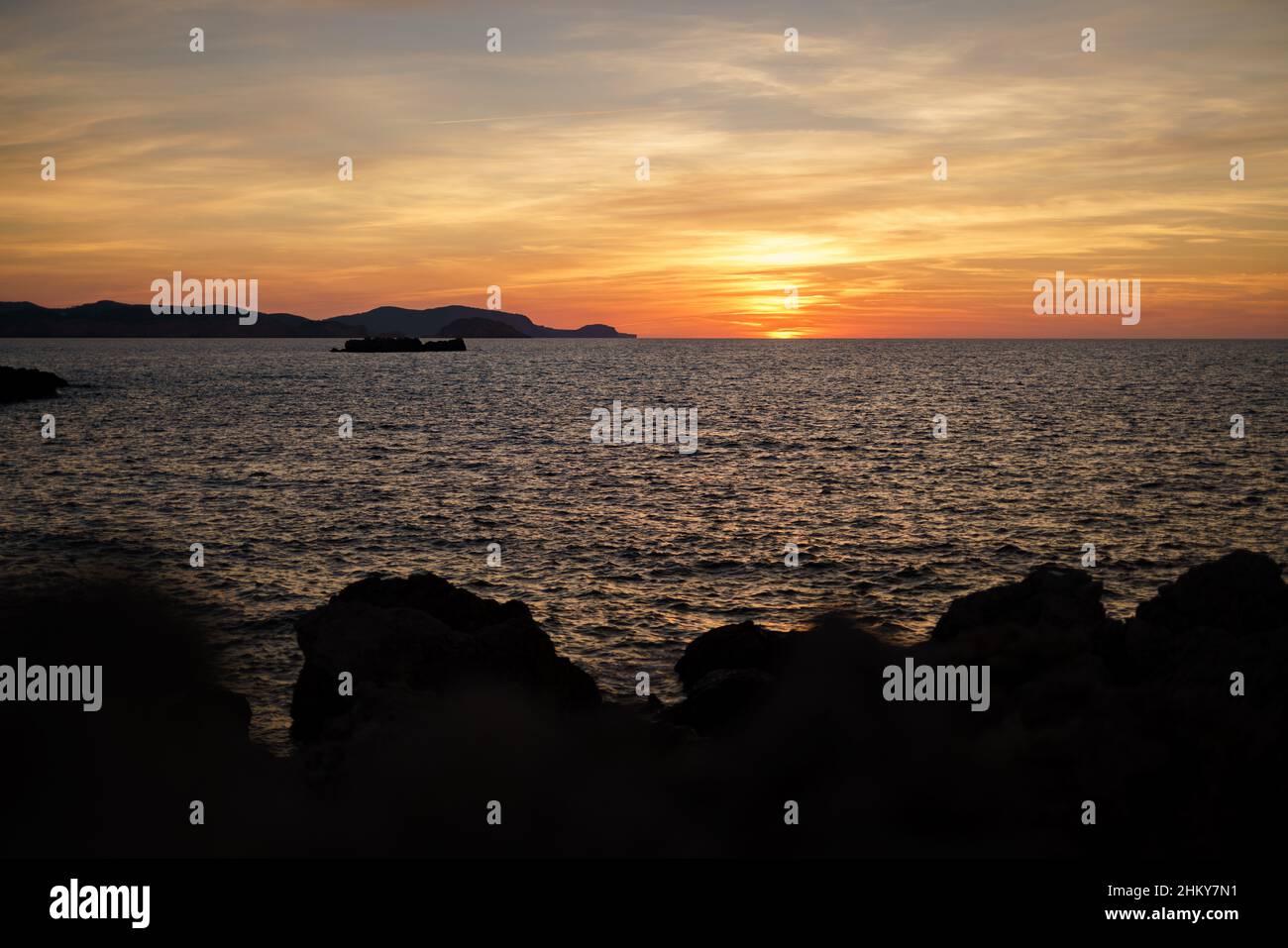 Orange sunset in Menorca Stock Photo - Alamy