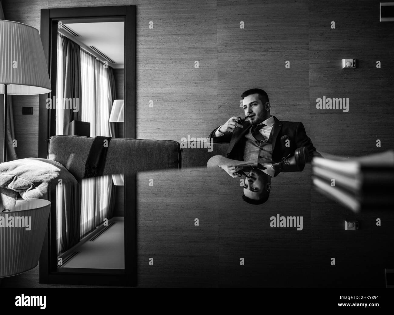a businessman smokes a pipe in a hotel room Stock Photo - Alamy