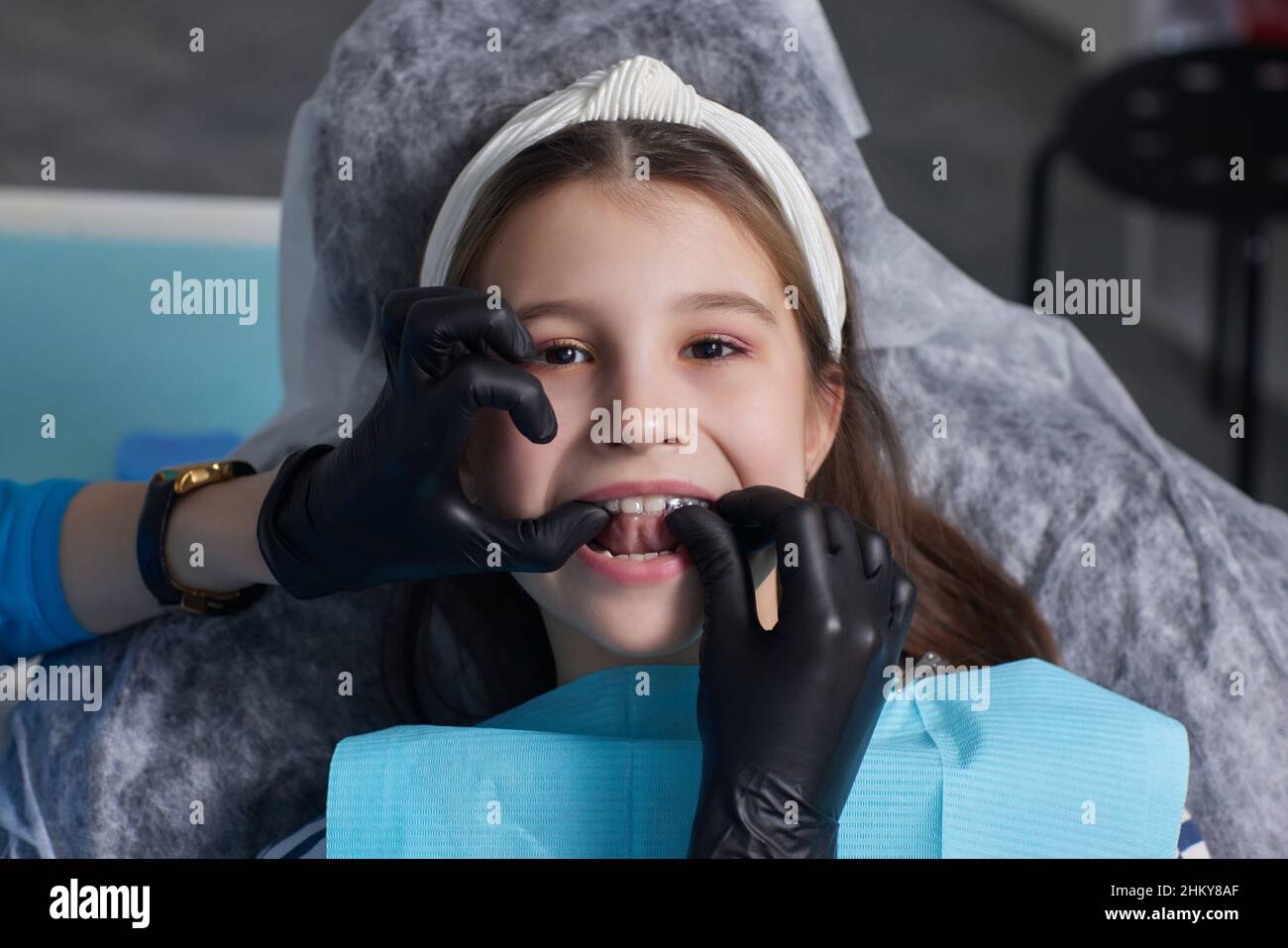 caucasian little kid girl invisible aligner and pointing to her perfect ...