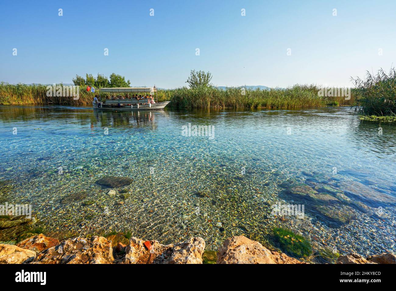 Crystal clear view of Azmak river with tourist boat in Akyaka. Akyaka ...