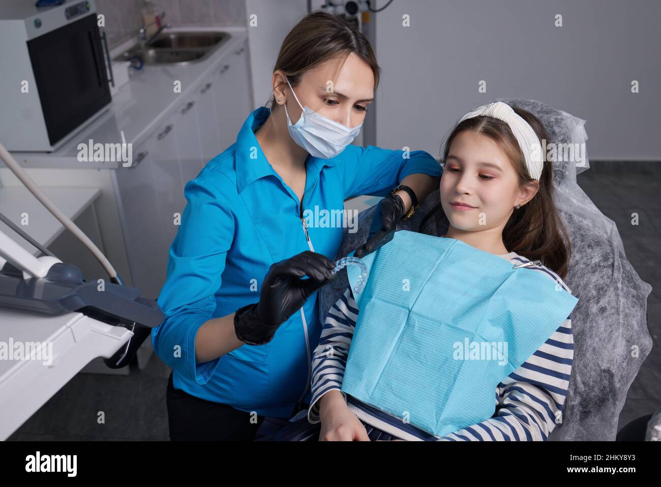 caucasian little kid girl invisible aligner and pointing to her perfect ...