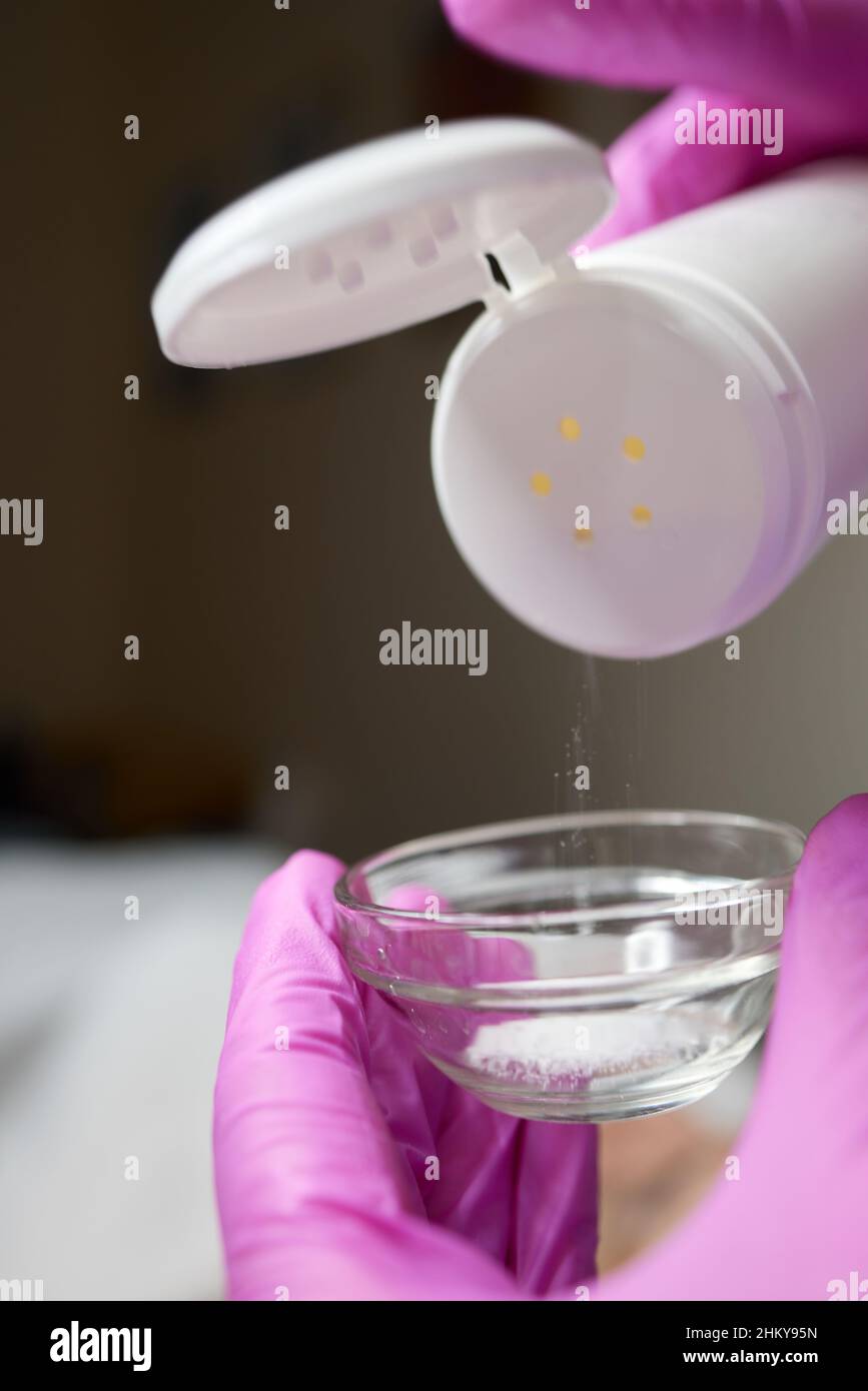 Woman's Hand Using Talcum Powder On Grey Background Stock Photo - Alamy
