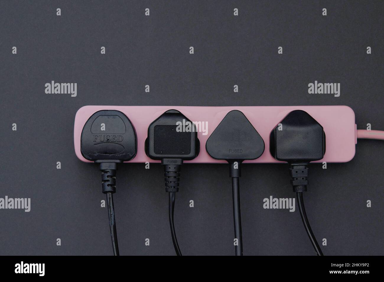 Colourful representation of a multi socket extension with plugs pugged ...