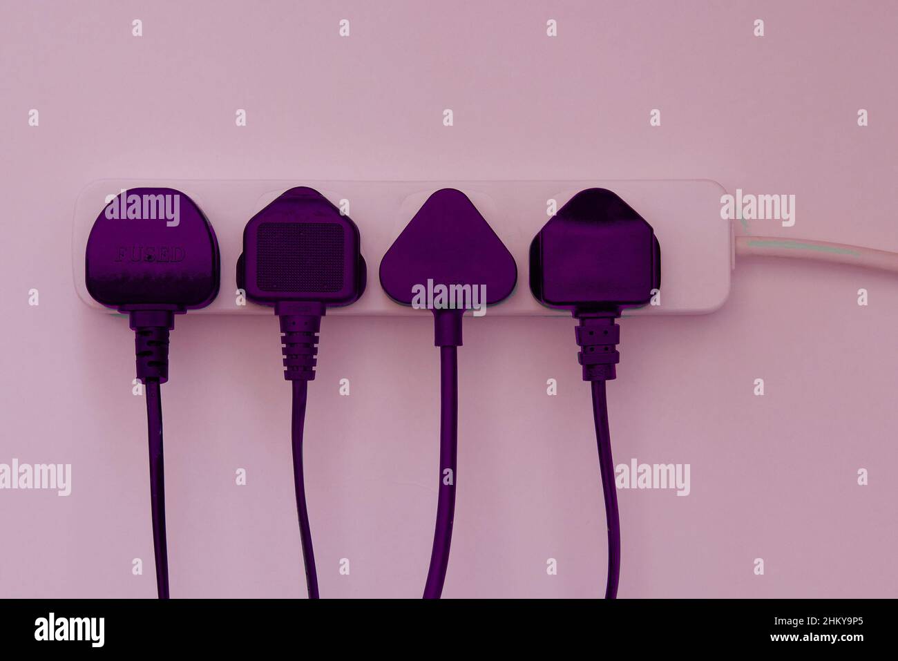 Colourful representation of a multi socket extension with plugs pugged ...