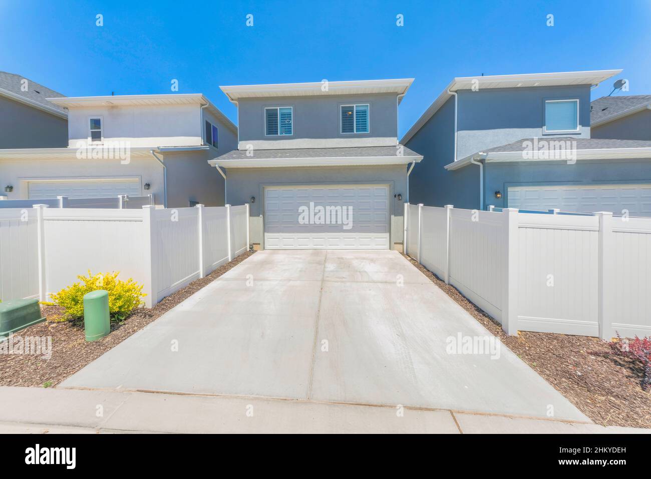 Attached garage at the back of a house with white vinyl fence Stock ...