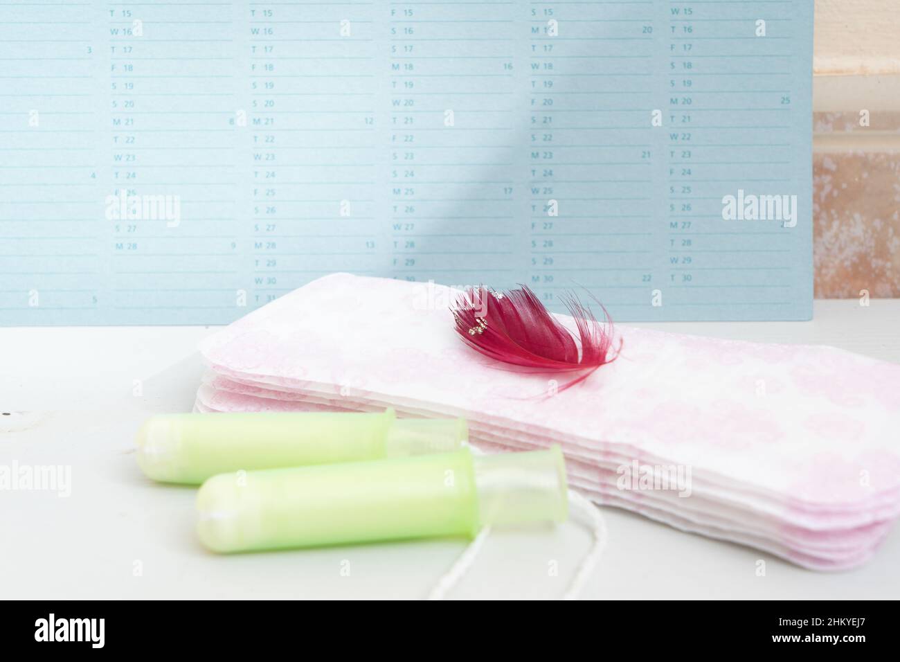 Menstrual pad with schedule card background Stock Photo - Alamy