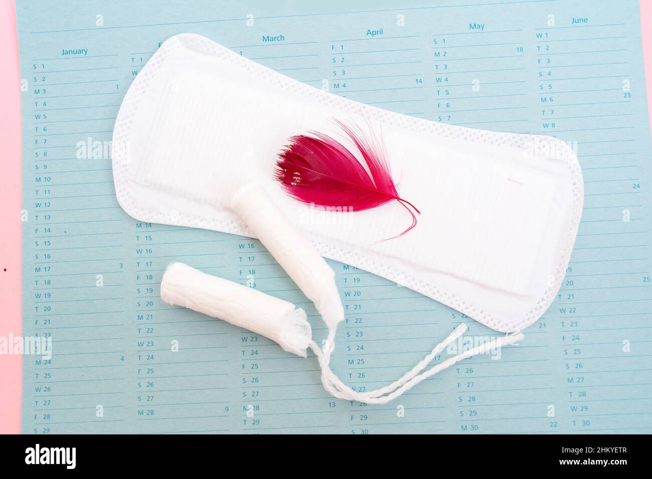 Menstrual pad with schedule card background Stock Photo - Alamy