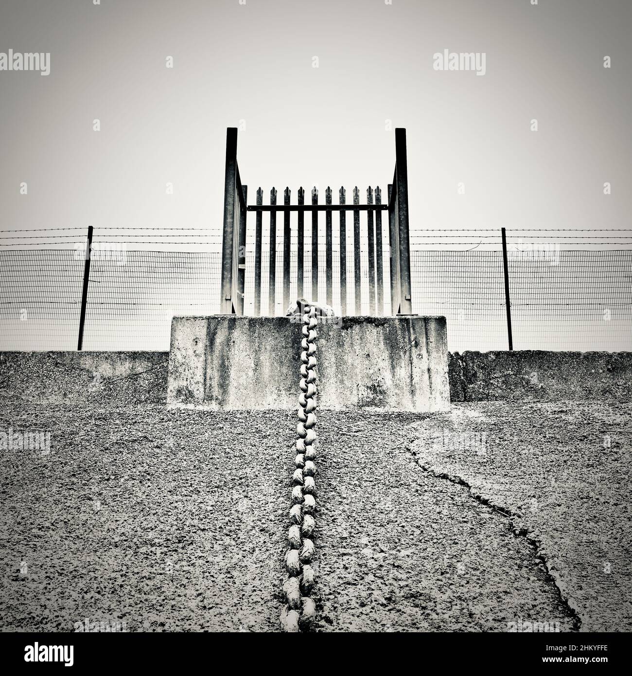 Ship mooring chain and metal fence guard on dockside Stock Photo - Alamy