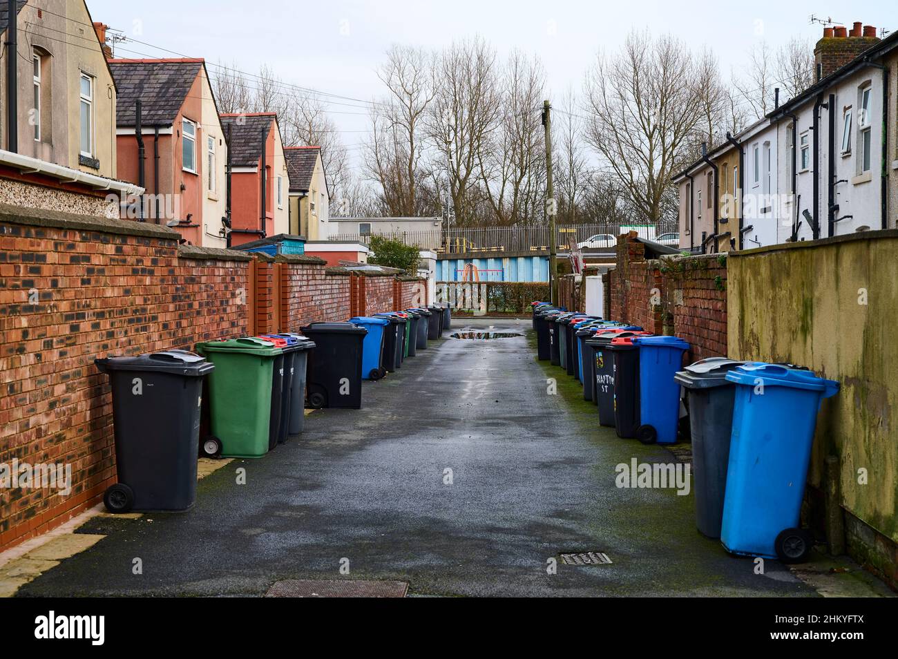 Many coloured wheelie bins lined up in alley way,Lancahire,UK Stock ...