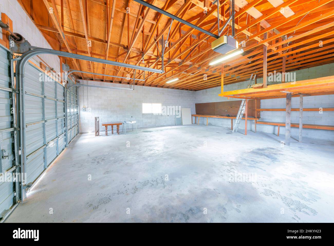 Large garage interior with automatic door operator machine Stock Photo ...