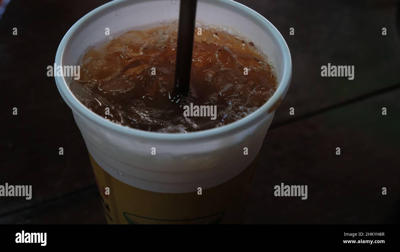 Ice Tea in a Plastic Cup with a Straw Stock Photo - Alamy