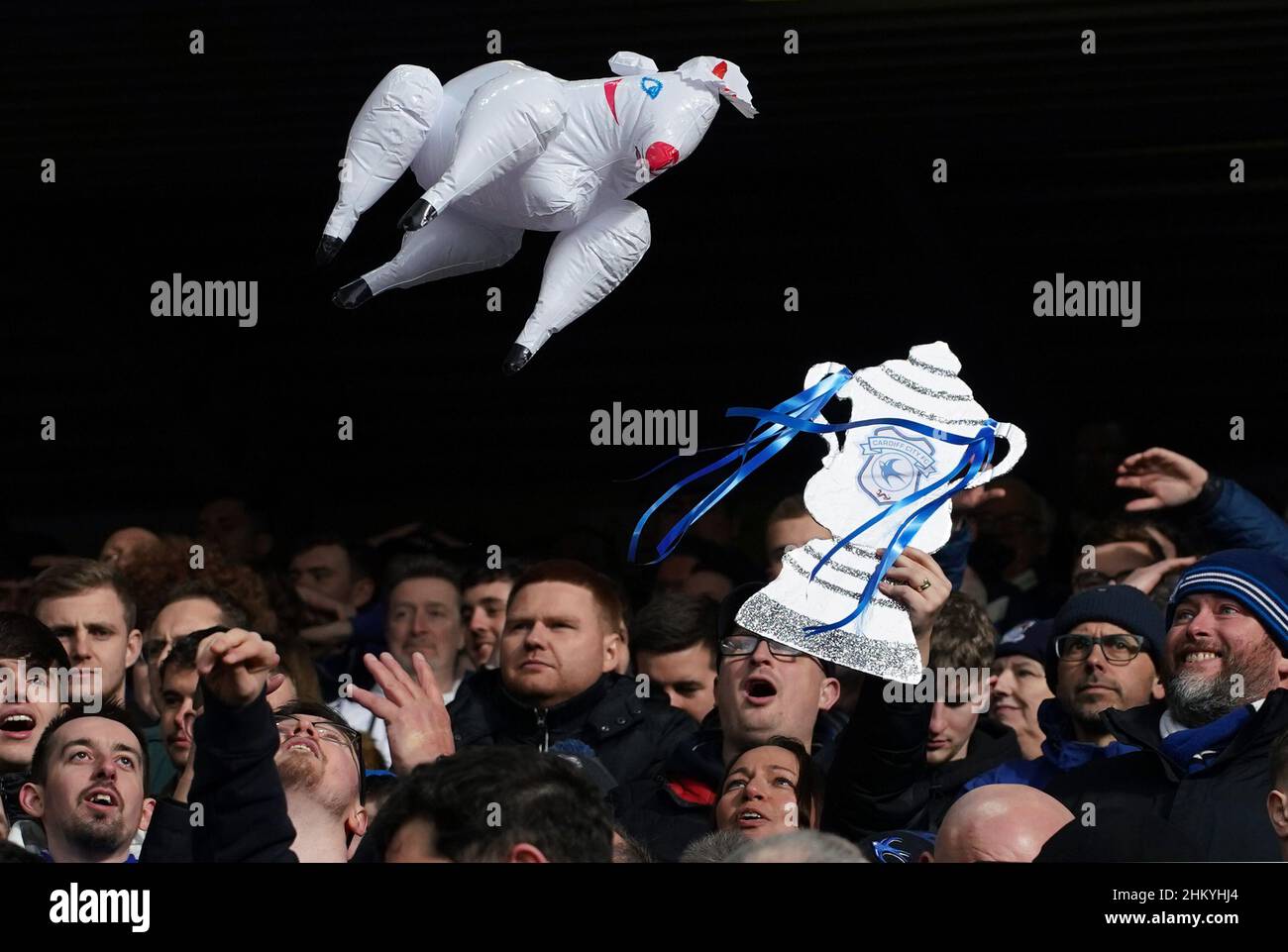 Cardiff City fans holding up a cardboard replica FA Cup and throwing a ...
