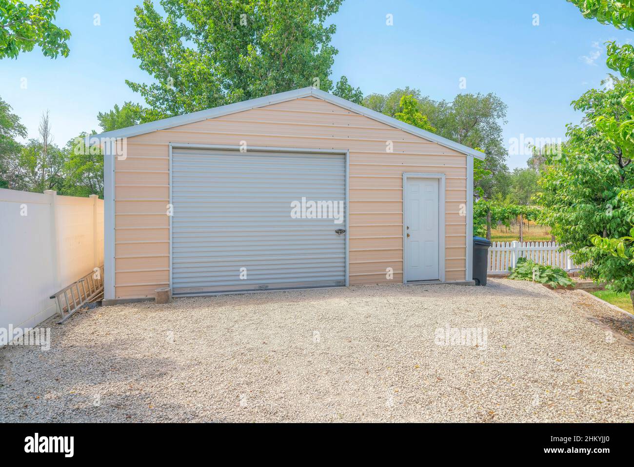 Detached gable garage exterior with steel walls and roll-up door with ...