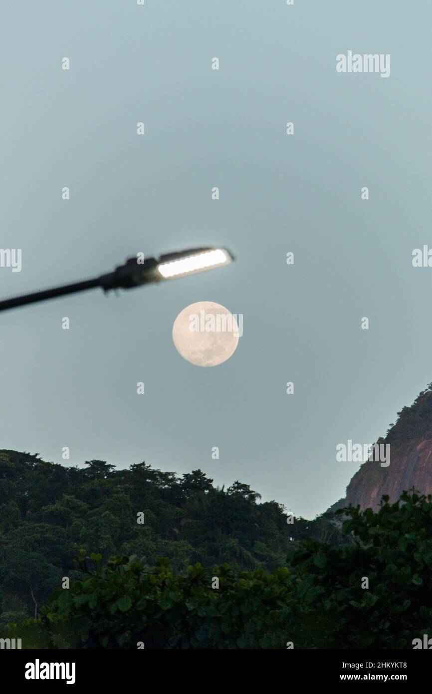 moon setting on a morning in the Copacabana neighborhood in Rio de ...