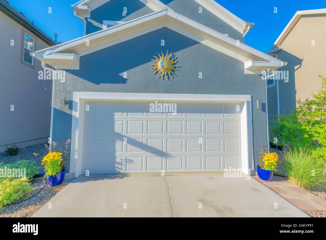 Attached garage with sun ornament on the blue gray wall exterior Stock ...