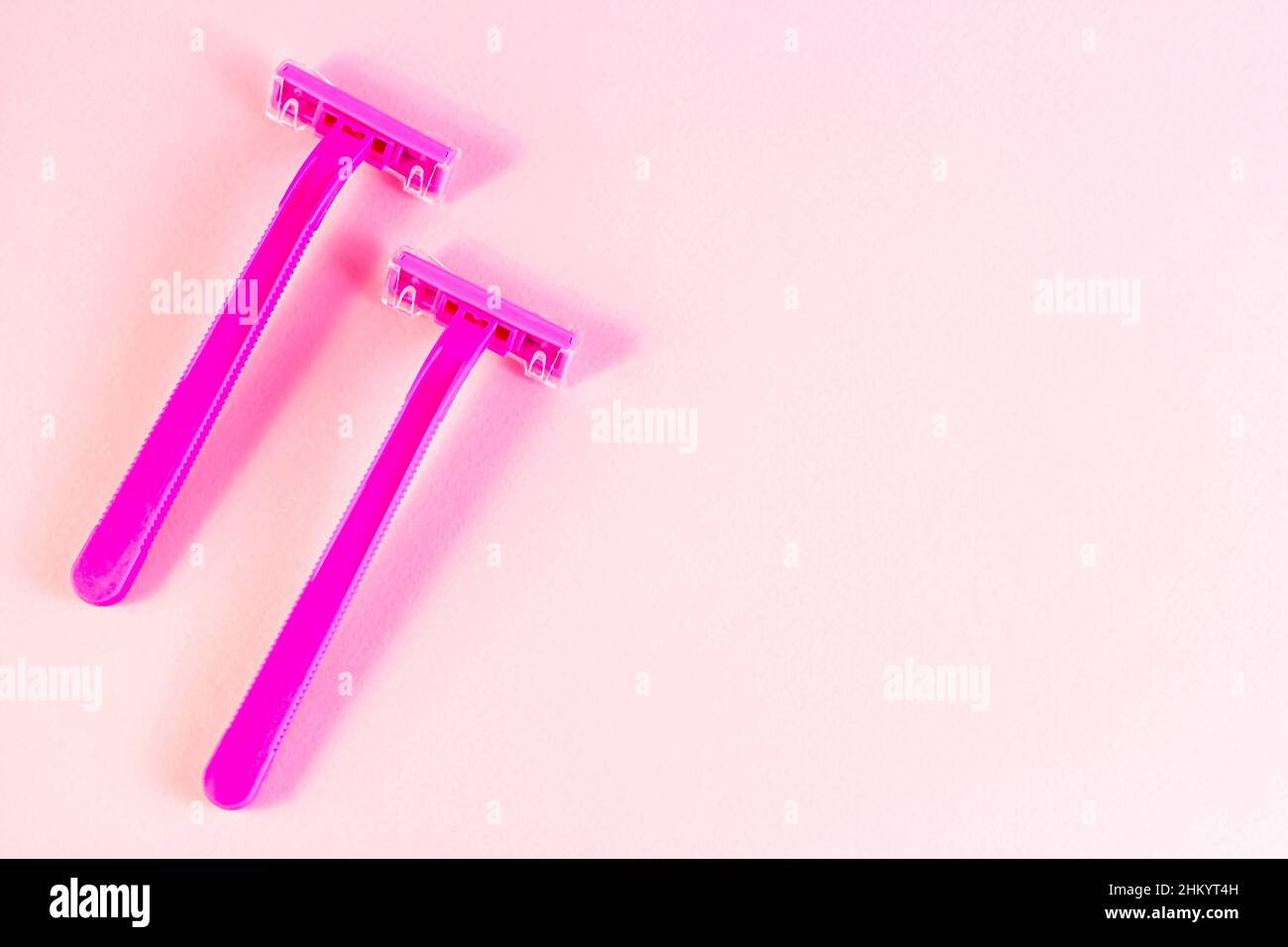 Pink disposable woman razor on light pastel background with copy space ...