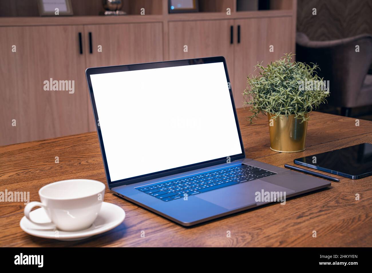 Laptop with white screen on the table. Work from home Stock Photo - Alamy