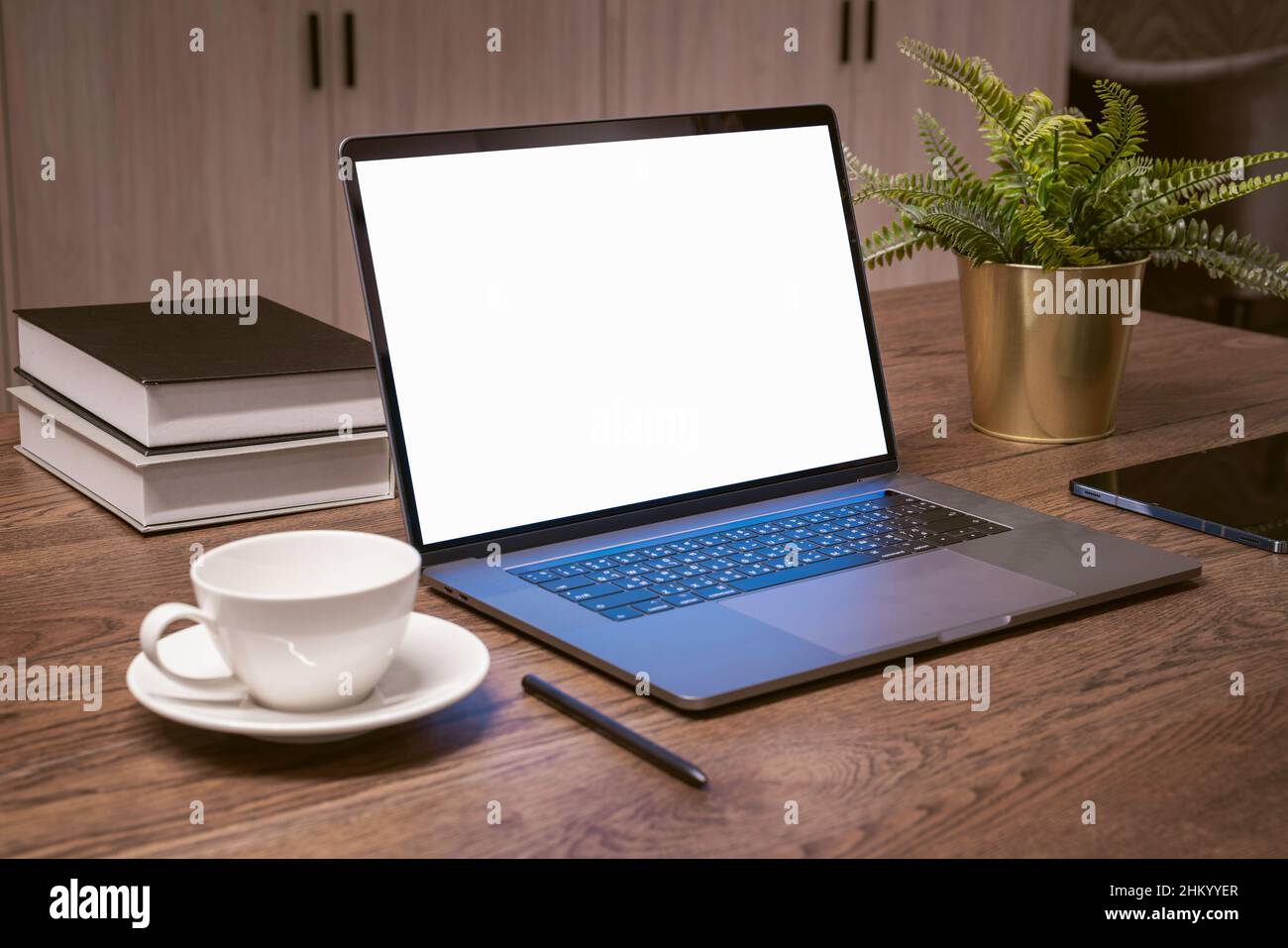 Laptop with white screen on the table. Work from home Stock Photo - Alamy
