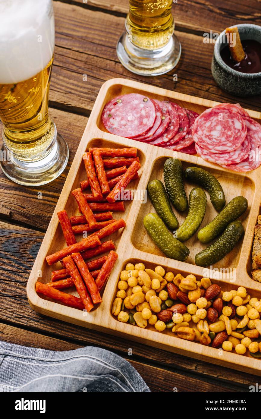 Snacks for beer for a male company. Sausage, croutons, nuts, gherkins ...