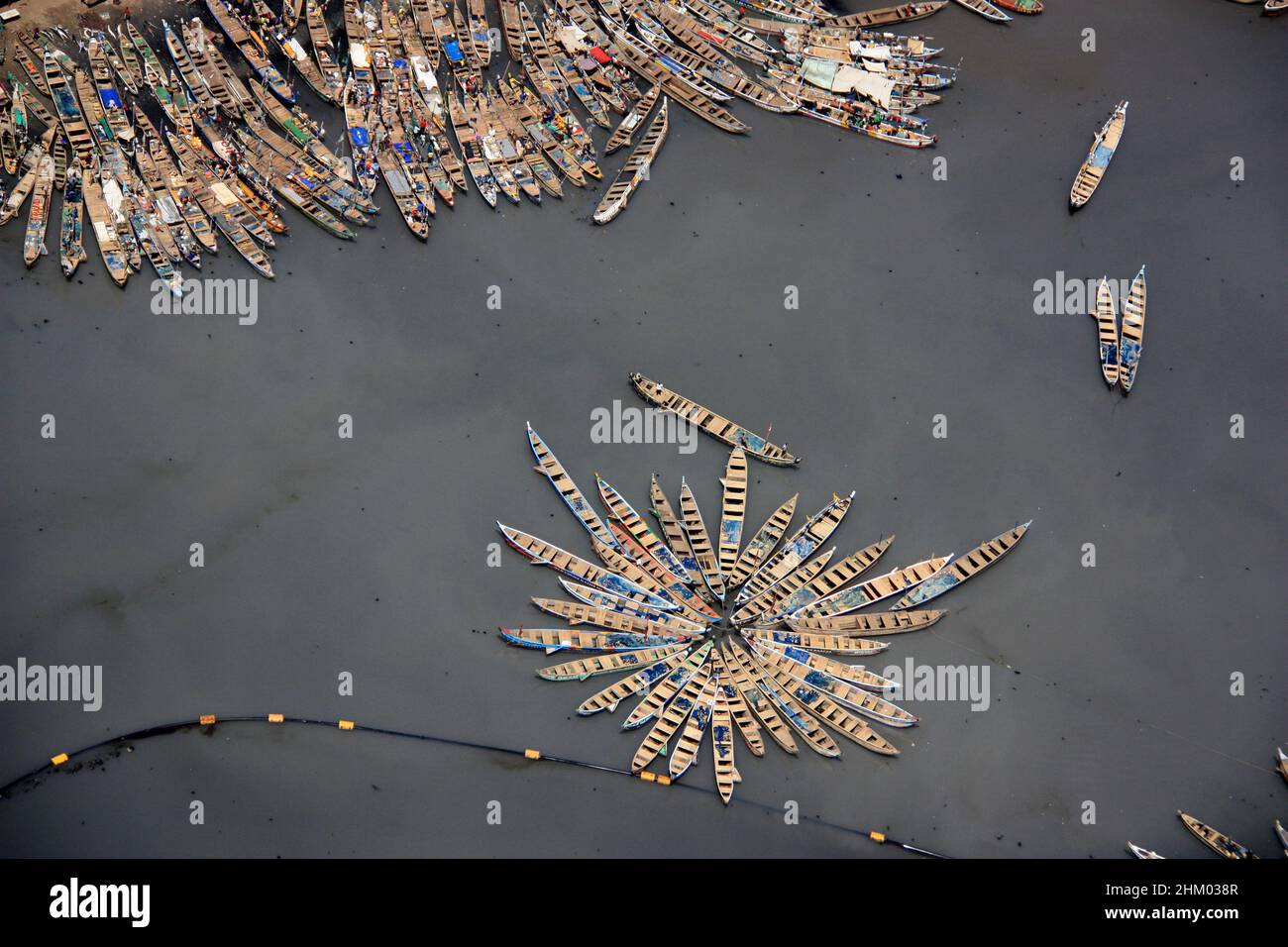 Aerial view of fishing boats moored together in the port of Tema ...
