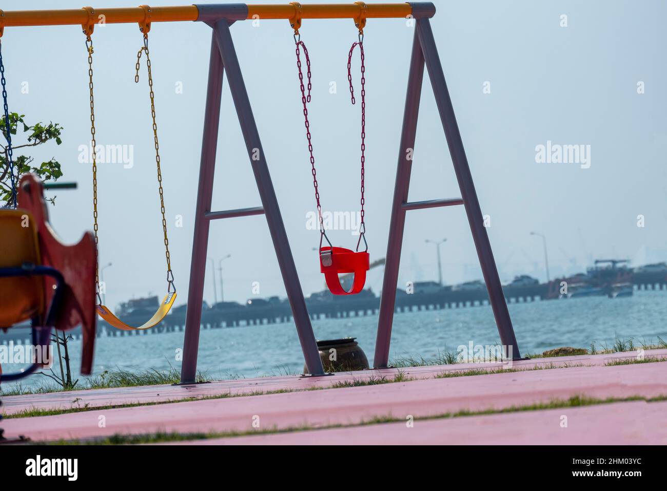 Red swings hi-res stock photography and images - Alamy