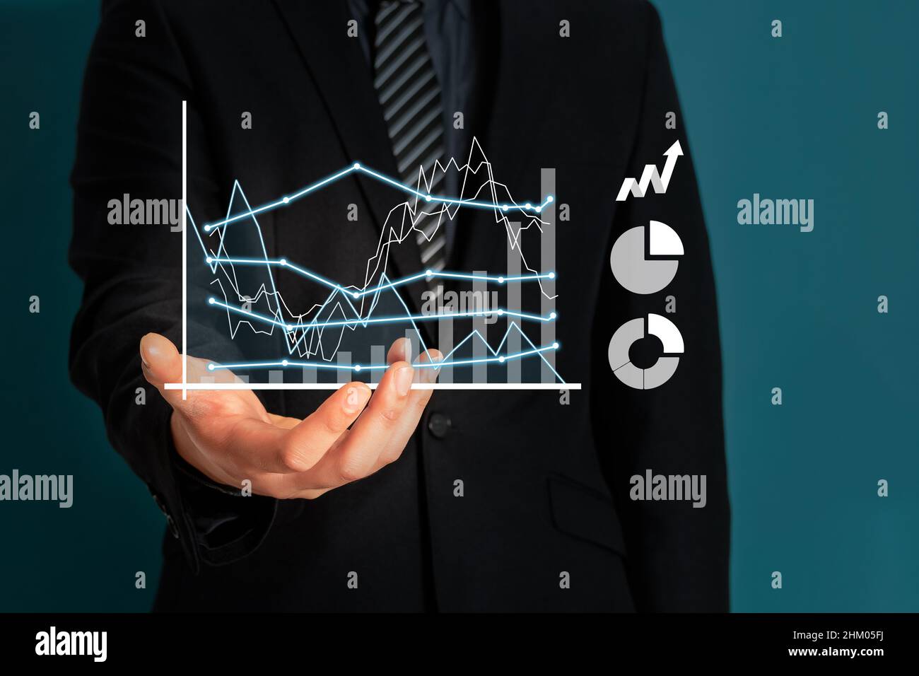 Businessman showing a growing virtual graph financial data, investing ...