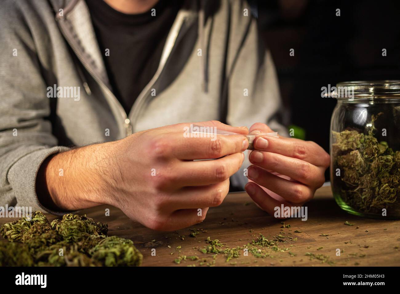 Man rolling marijuana cannabis joint in coffee shop Amsterdam with CBD ...